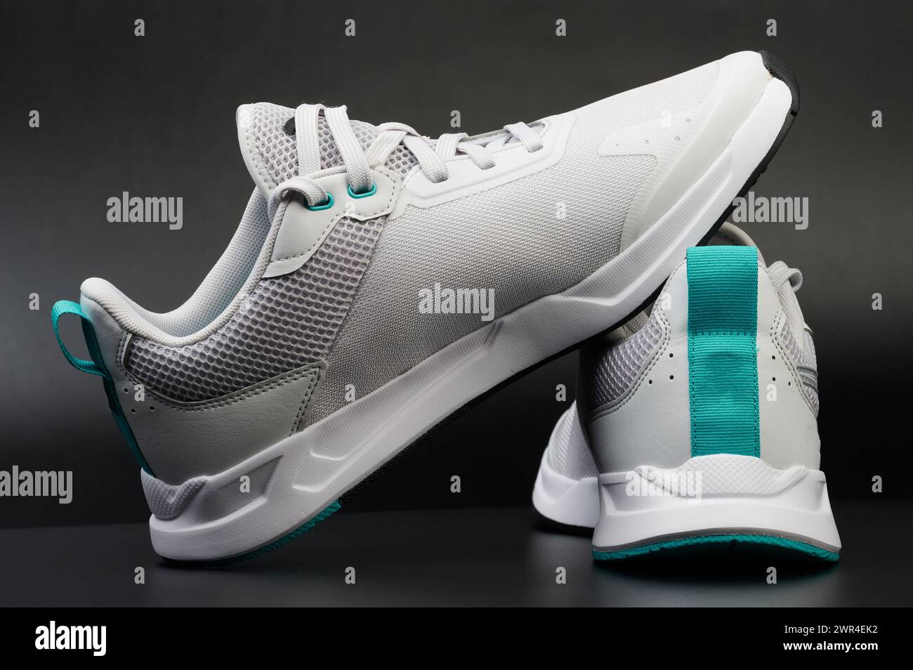 Athletic white pair shoes side and rear view isolated on black studio ...