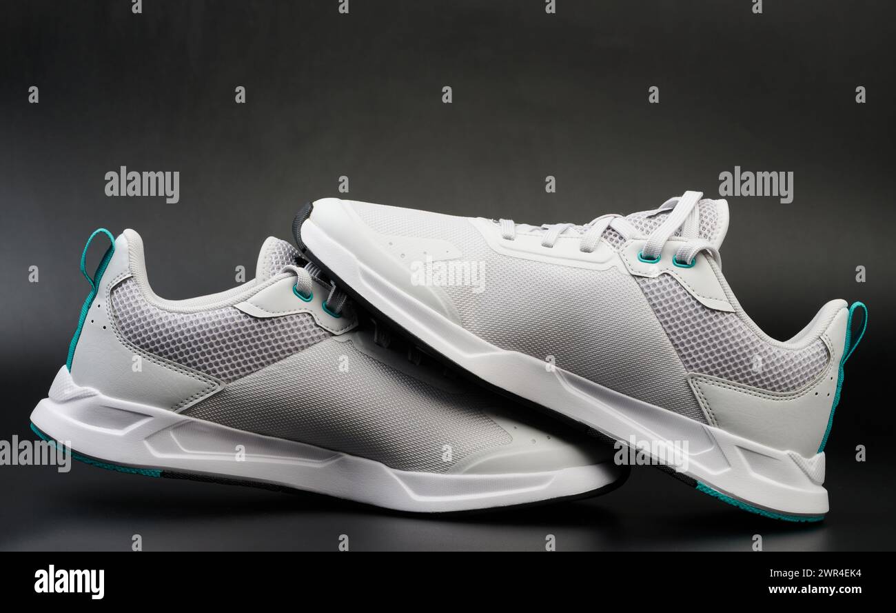 White fitness sport shoes side view isolated on black studio background ...