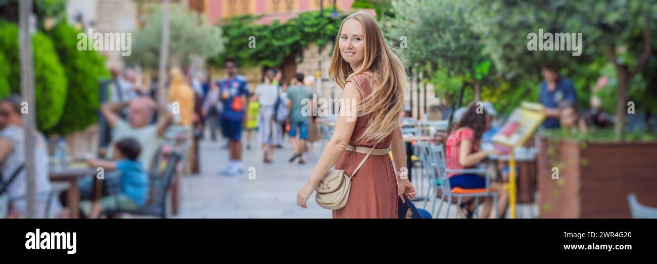 BANNER, LONG FORMAT Happy woman tourist on background of old street of ...