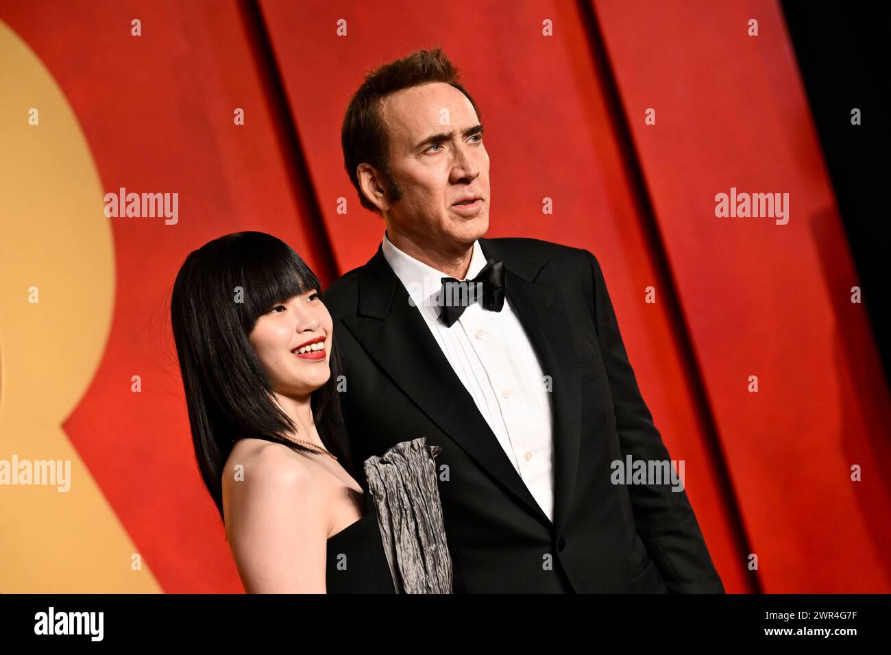 Riko Shibata, left, and Nicolas Cage arrive at the Vanity Fair Oscar ...