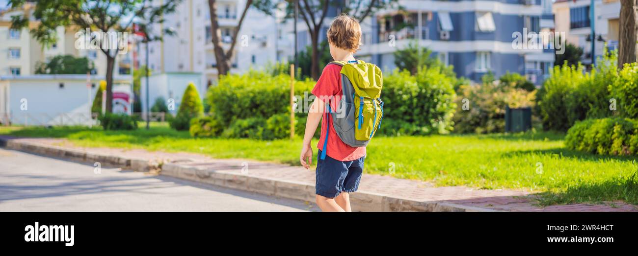 Little boy with a backpack go to school. Back view BANNER, LONG FORMAT ...