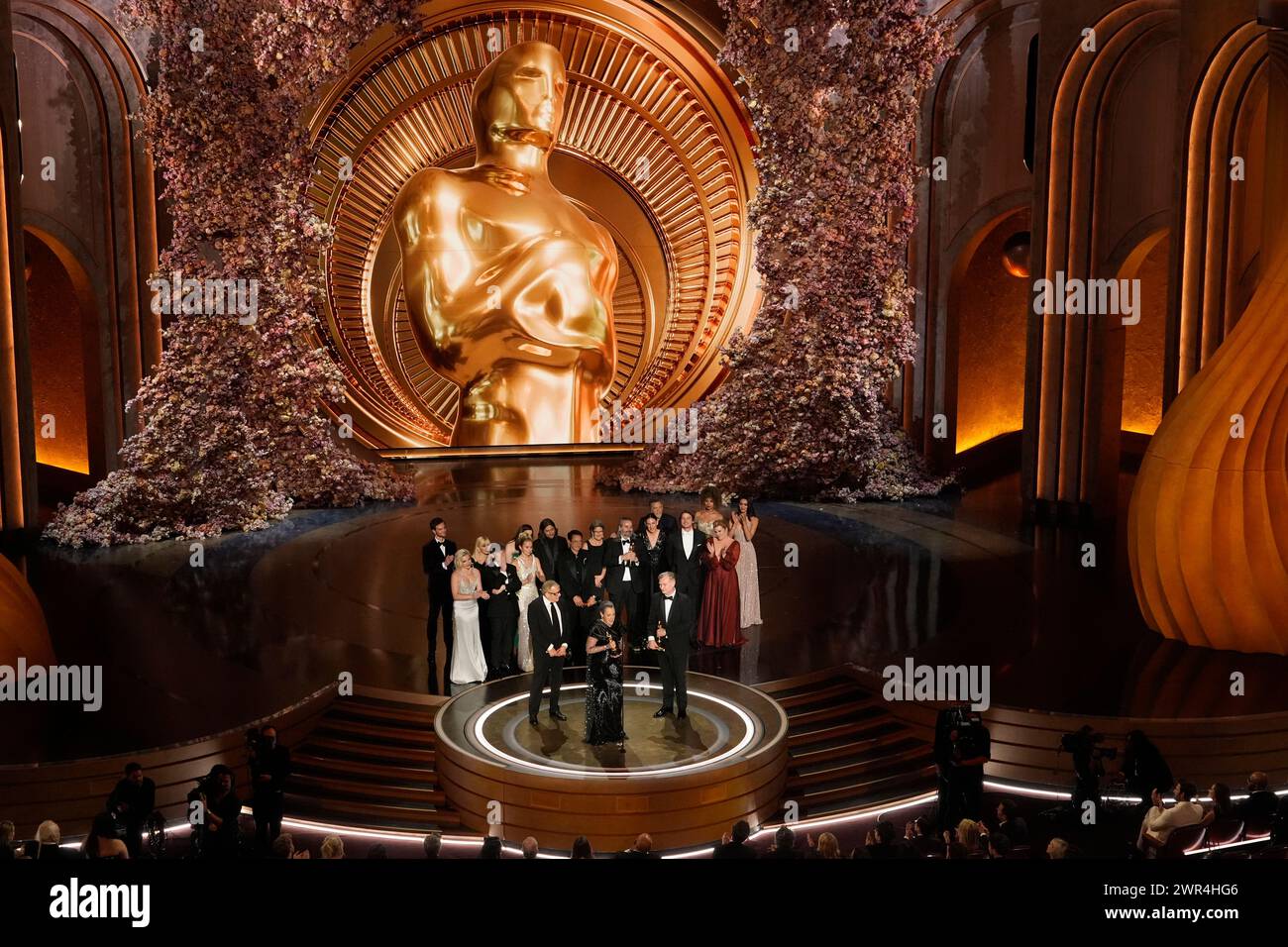 The cast and crew of "Oppenheimer" accept the award for best picture ...