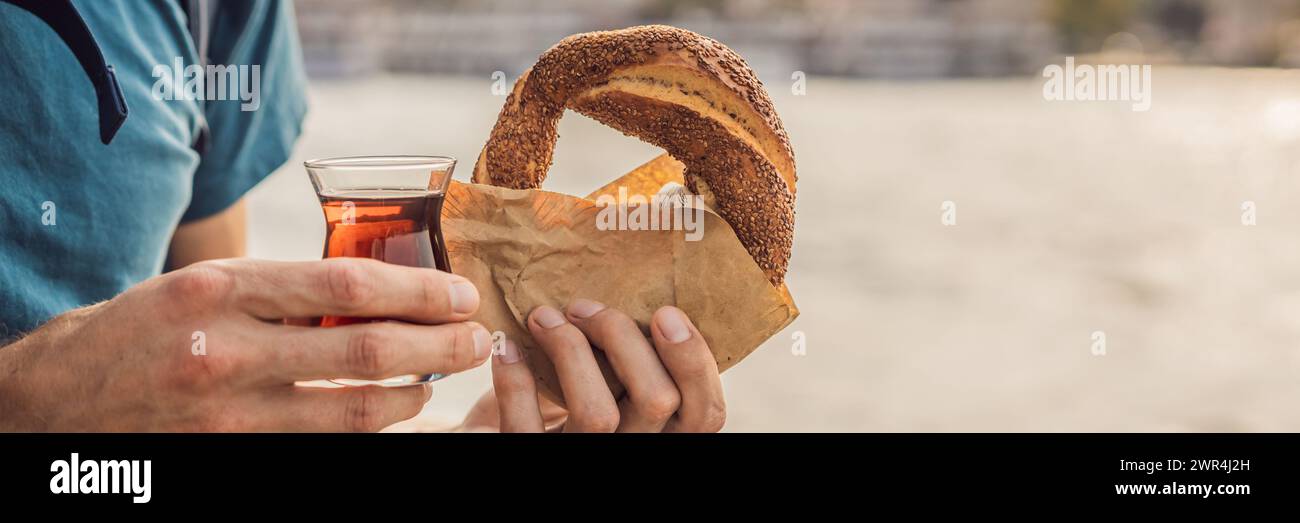 BANNER, LONG FORMAT Man in Istanbul having breakfast with Simit and a ...