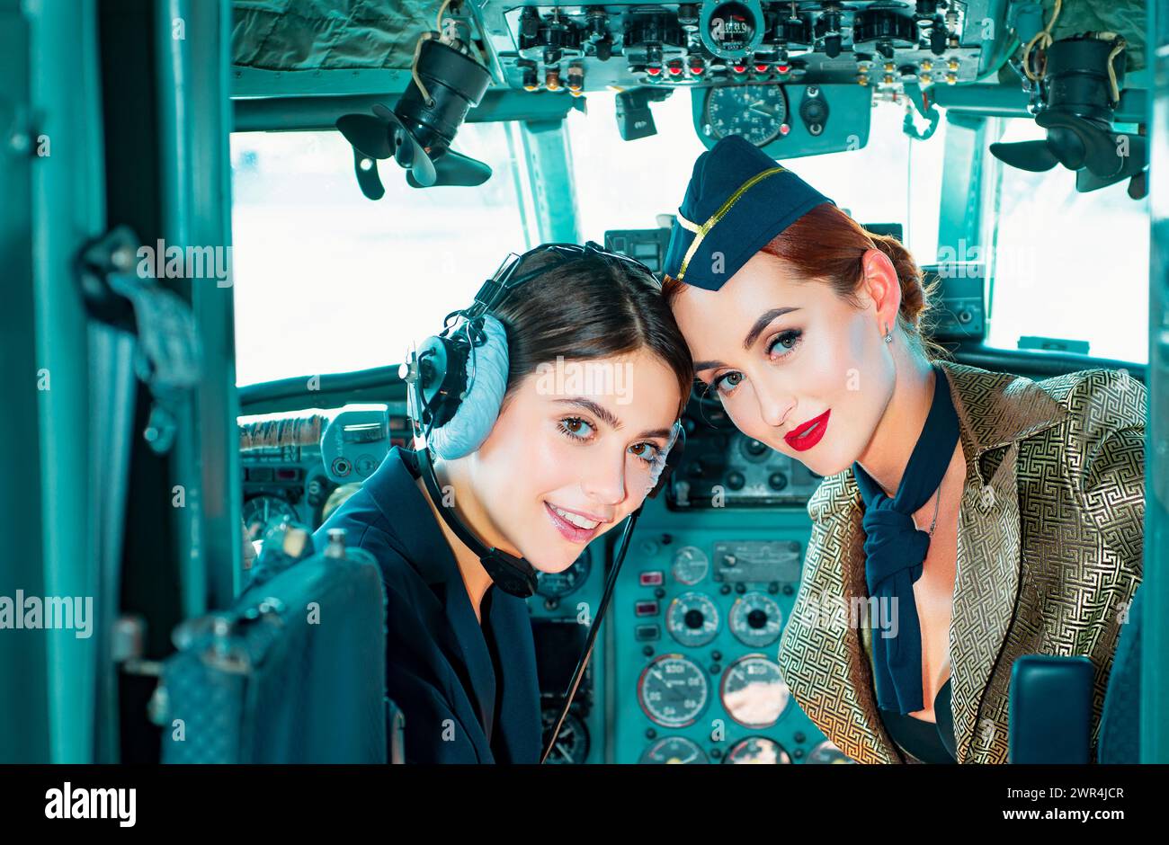 Two women Pilots Sitting in Cabin of Modern Aircraft. Smiling ...