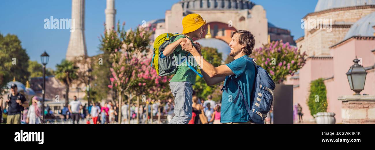 BANNER, LONG FORMAT Father and son Tourists enjoy beautiful view on ...