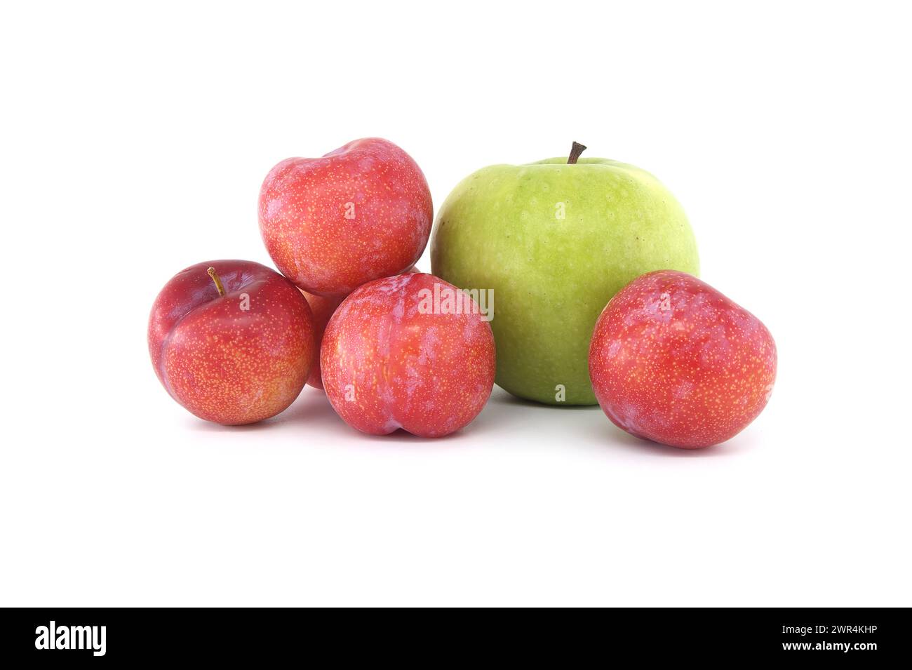 Collection of fresh fruits comprising red plums and bright green apple ...