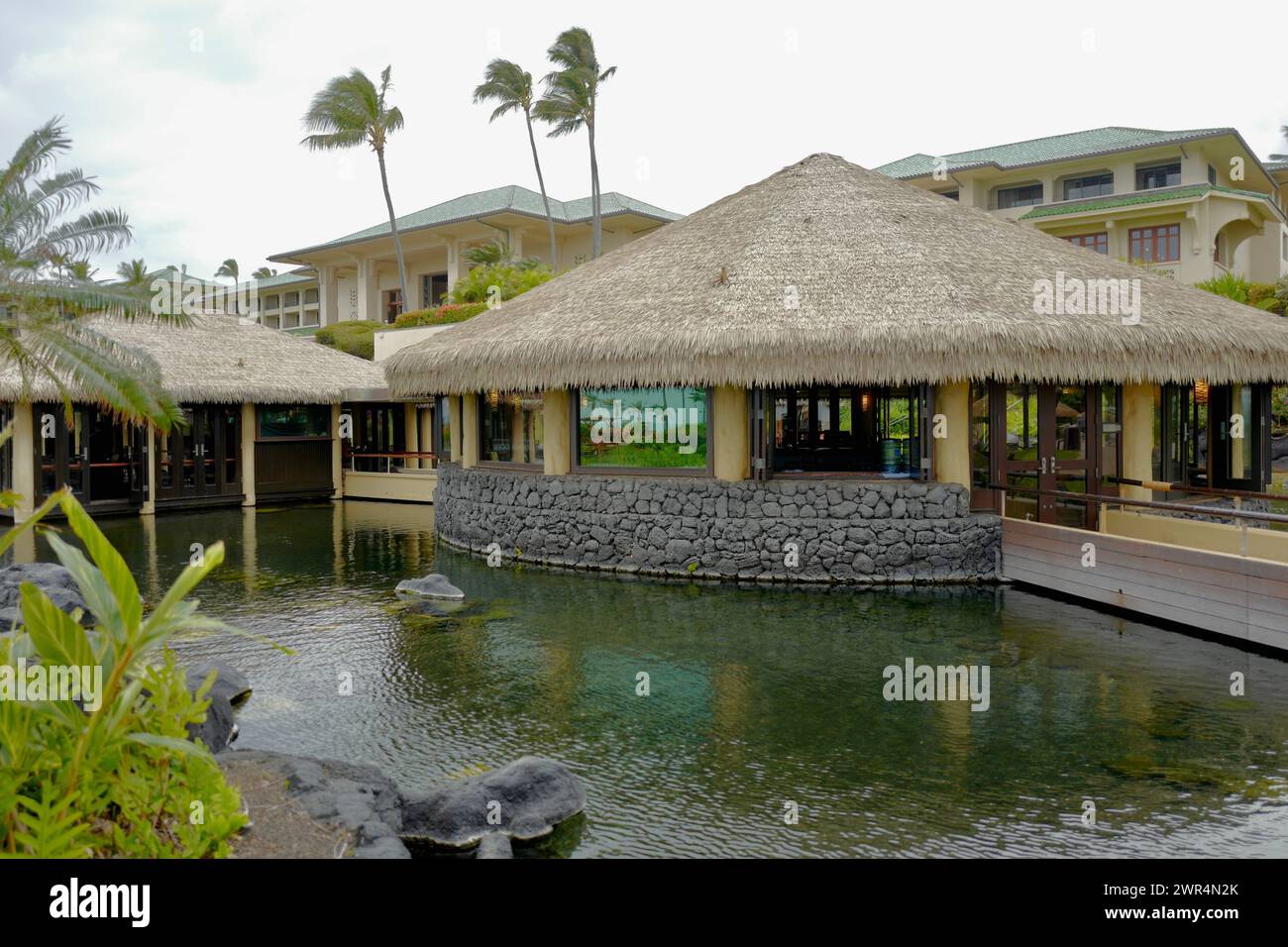 Round thatched hut at a pond in a tropical setting Stock Photo - Alamy