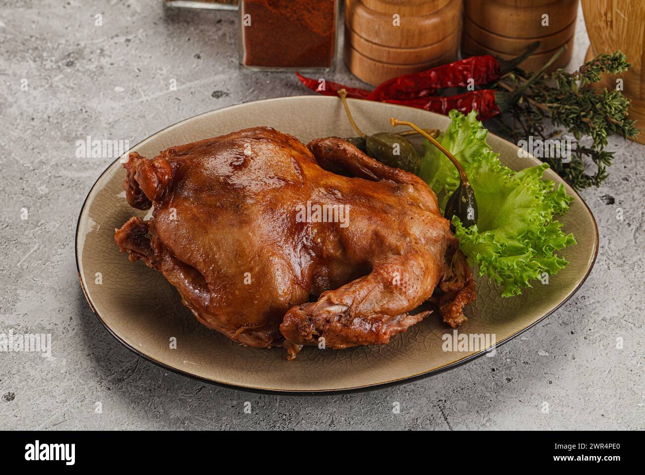 Baked whole small chicken with spices Stock Photo - Alamy