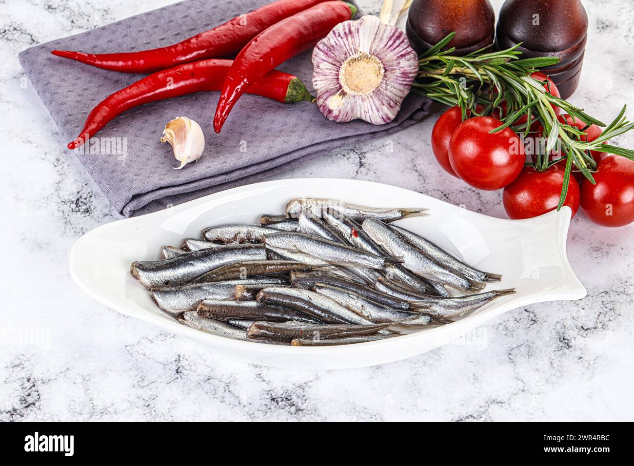 Pickled anchovy fish in the plate Stock Photo - Alamy