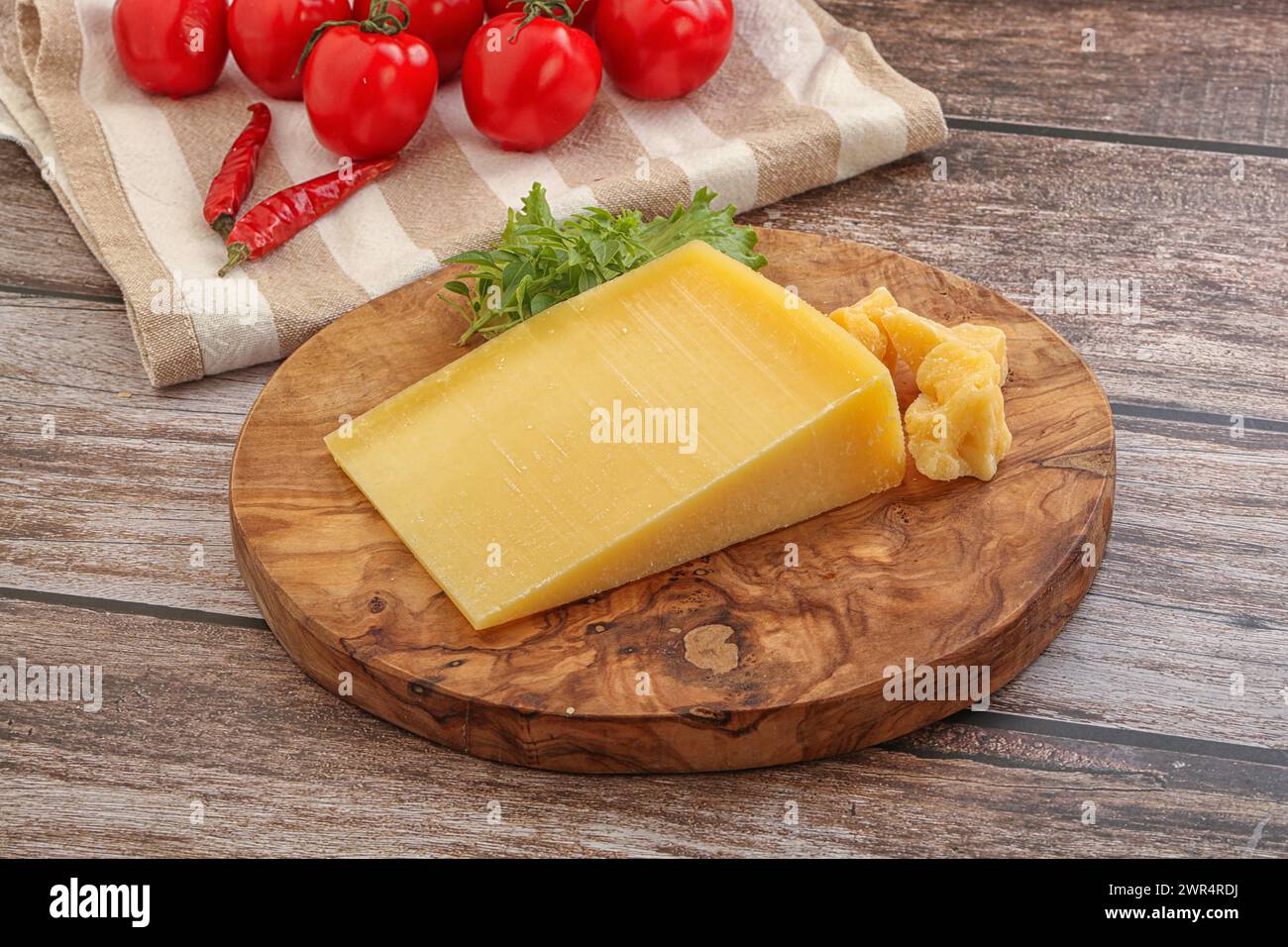 Parmesan hard cheese with small pieces over board Stock Photo - Alamy