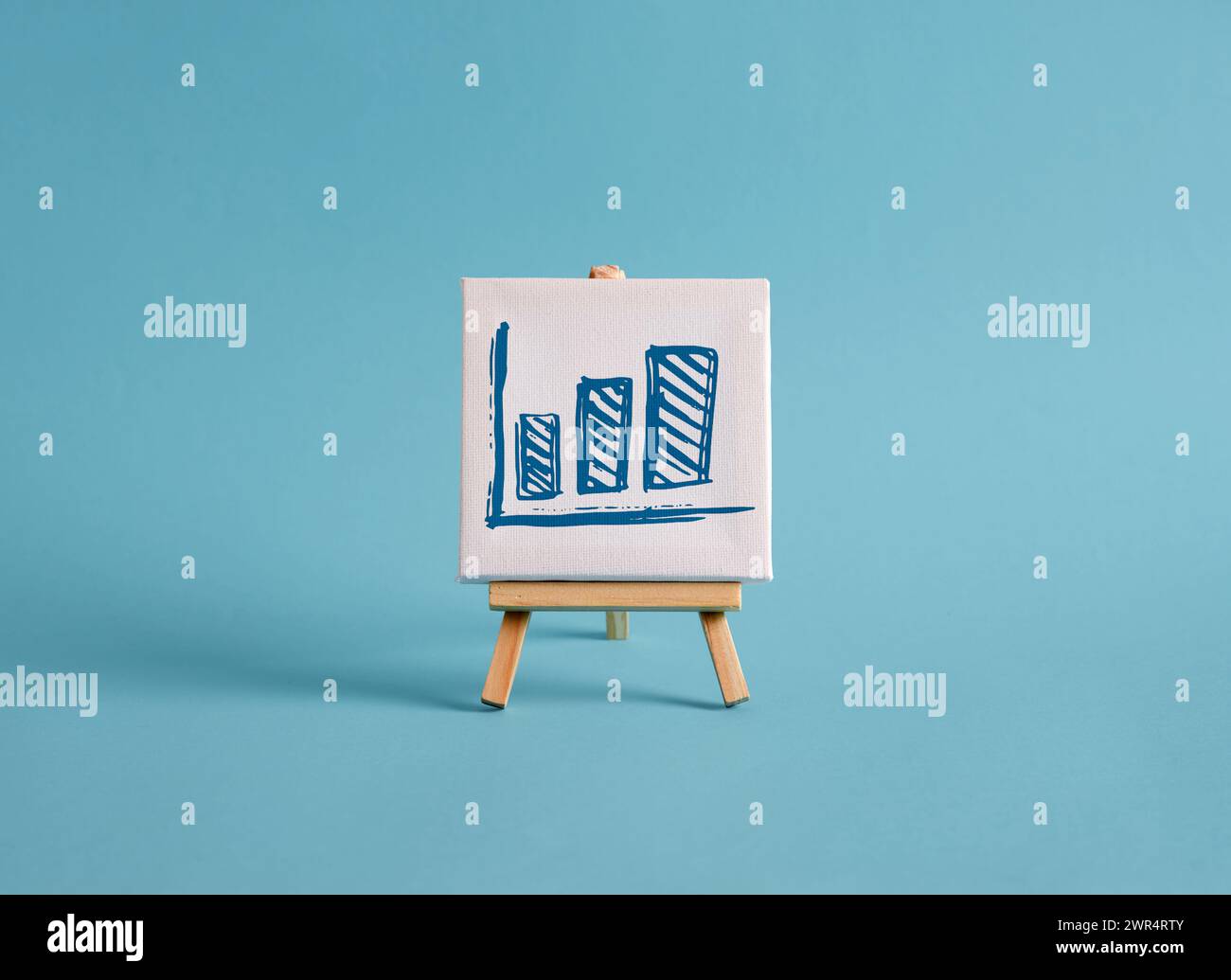 A canvas with an increasing growth chart on an easel with blue ...