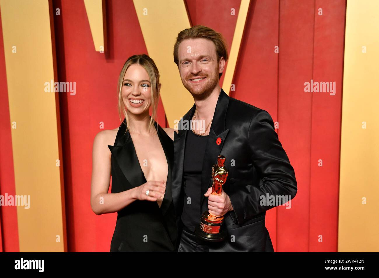 Claudia Sulewski, left, and Finneas O'Connell arrive at the Vanity Fair ...
