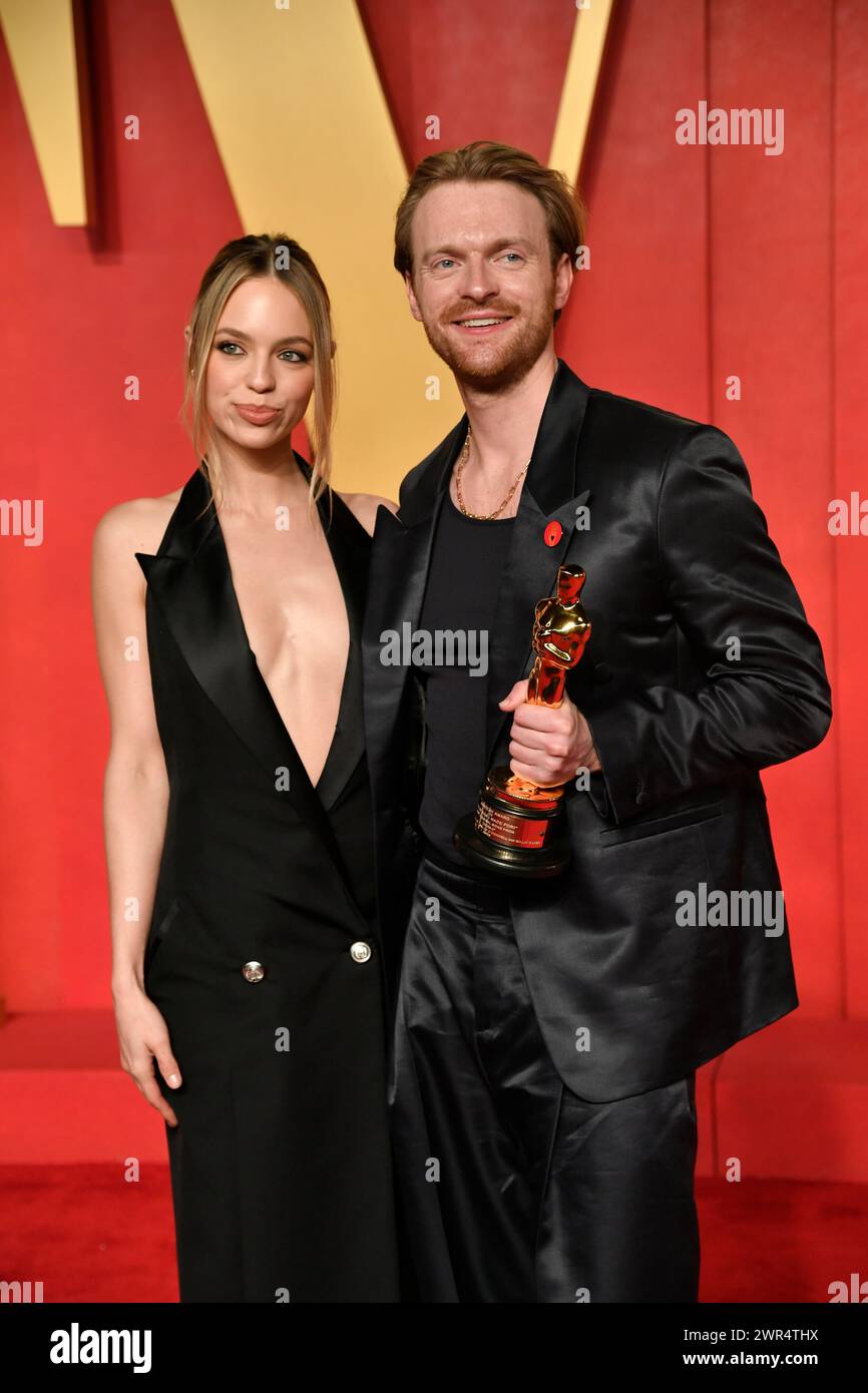 Claudia Sulewski, left, and Finneas O'Connell arrive at the Vanity Fair ...