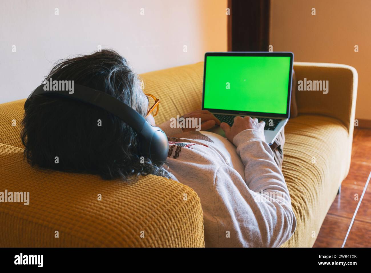 Man sitting on couch displaying hi-res stock photography and images - Alamy