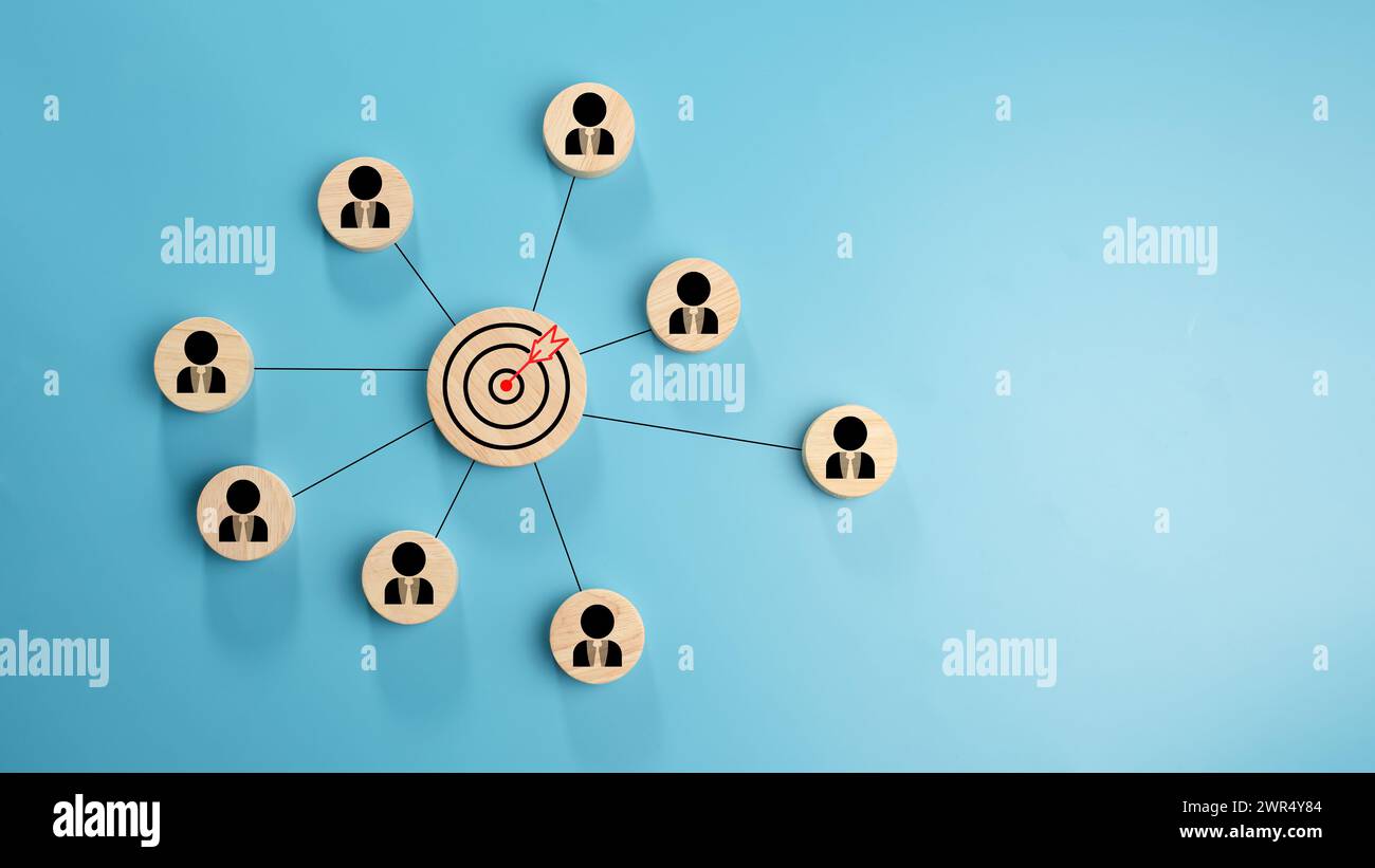 Circular wood with printed target icons and business symbols on light ...