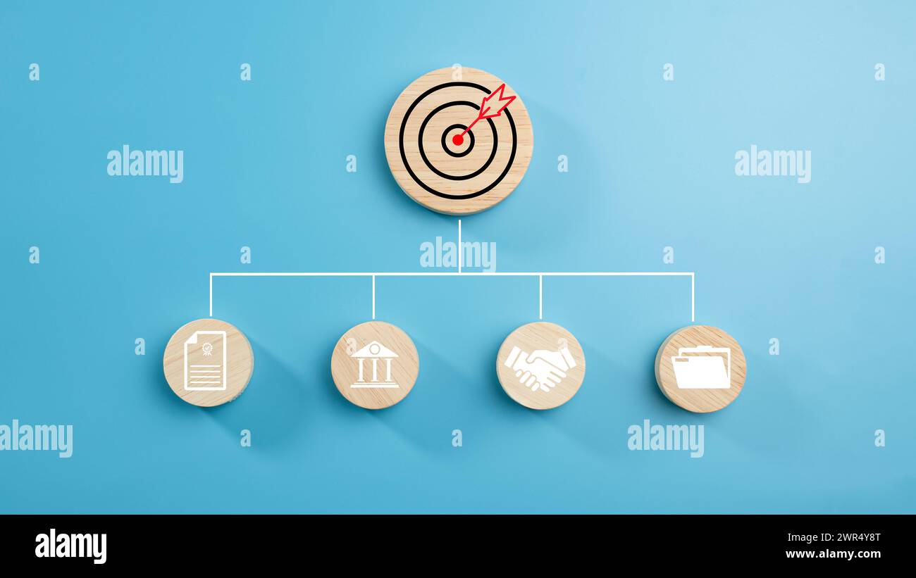 Circular wood with printed target icons and business symbols on light ...