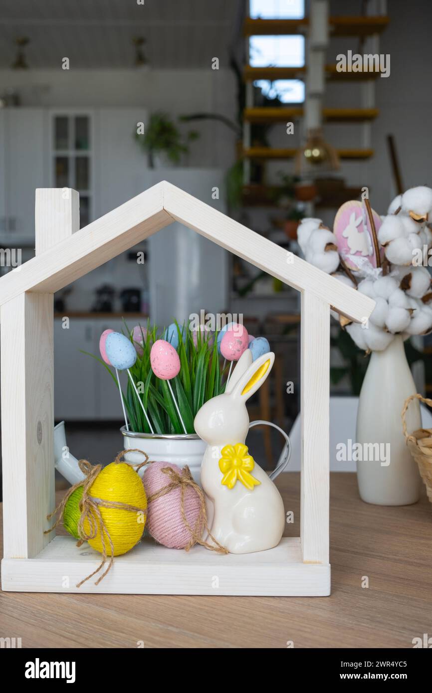 Tiny house of cozy home with Easter decor with rabbit and eggs on table ...