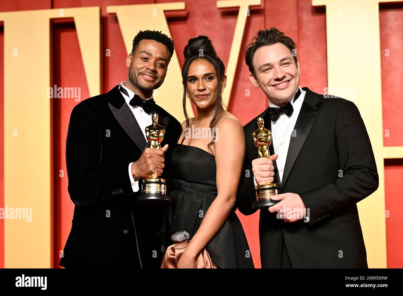 Kris Bowers, from left, Briana Nicole Henry, and Ben Proudfoot arrive at the Vanity Fair Oscar ...