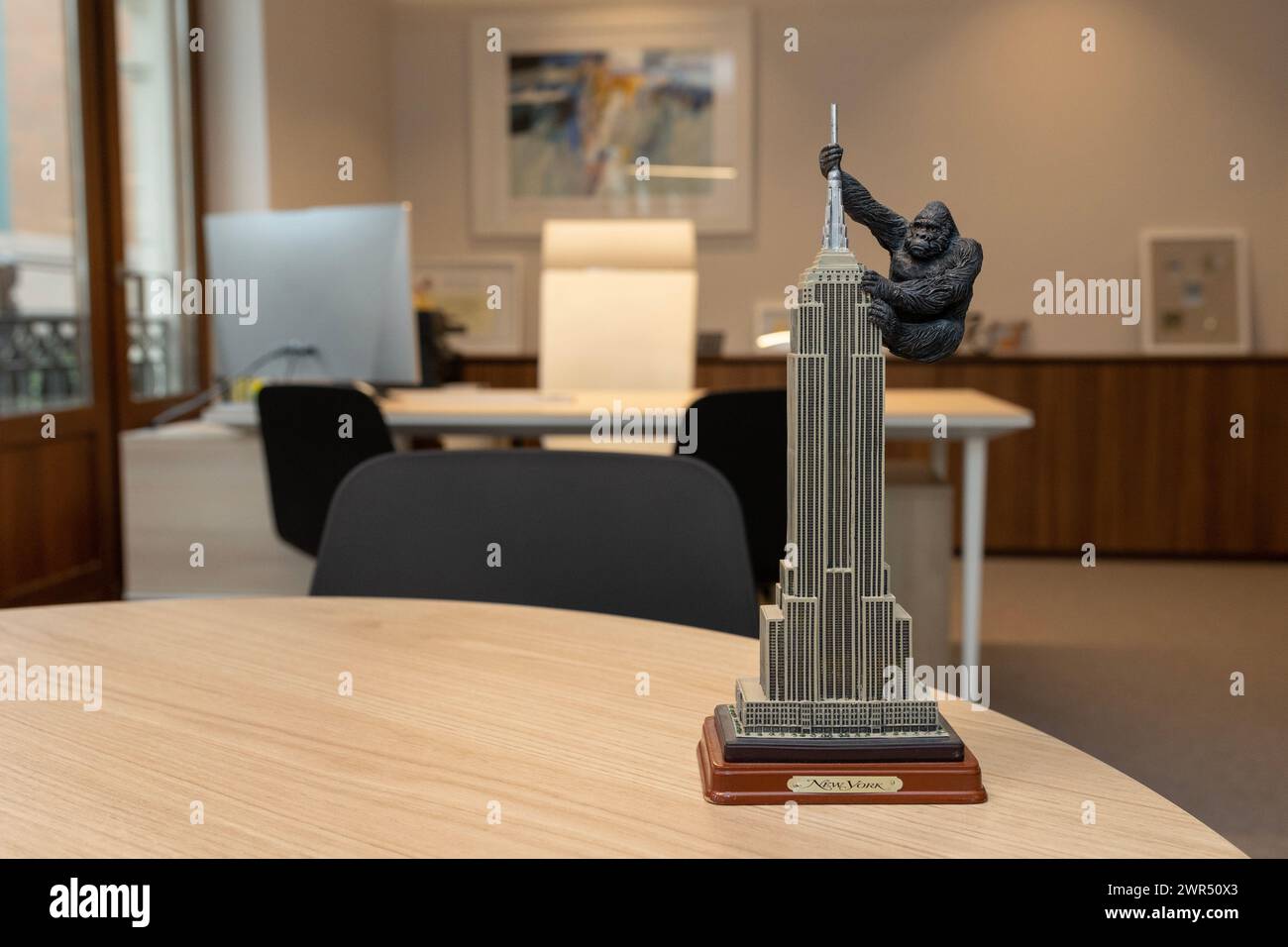 A miniature Empire State Building model on a desk in an office setting ...