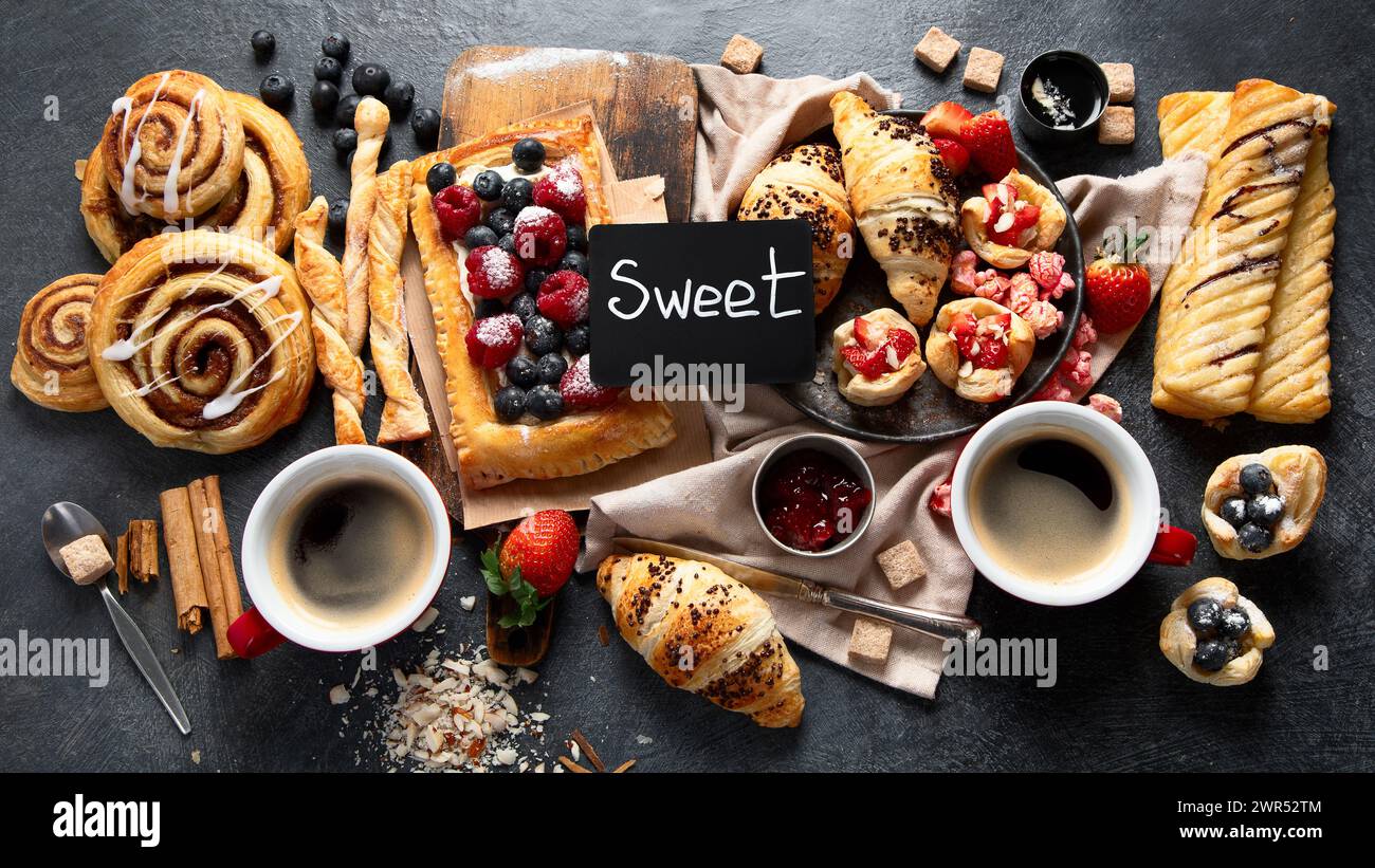 Different tasty freshly baked pastries on dark background. Top view ...