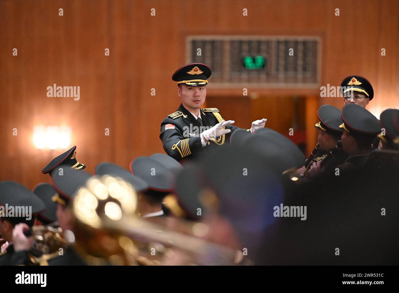 11 March 2024, China, Peking: A conductor of the band of the People's ...