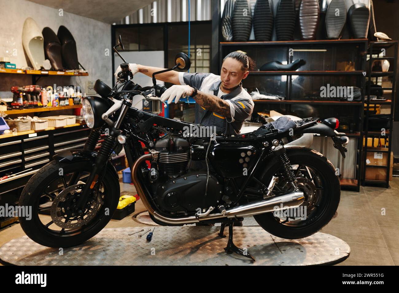 Mechanic working in motorcycle repair workshop Stock Photo - Alamy