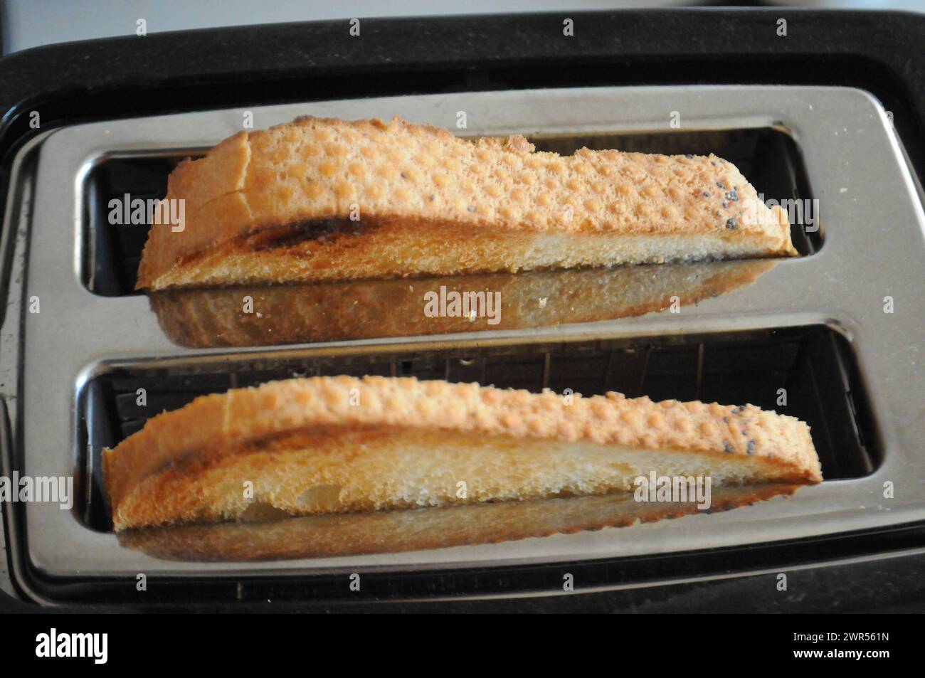 Copenhagen, Denmark /11 March 2024/ Bread toaster and slices f toasted ...