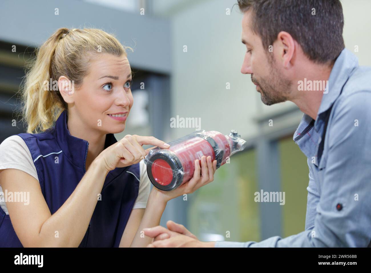 woman holding small fire extinguisher Stock Photo - Alamy
