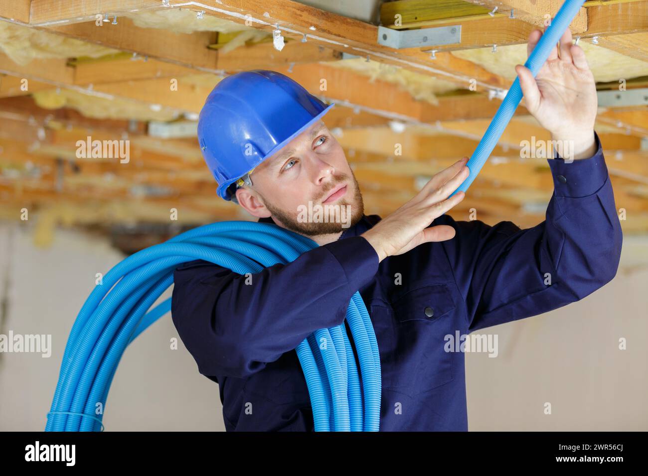 electrician working with wires in construction site Stock Photo - Alamy