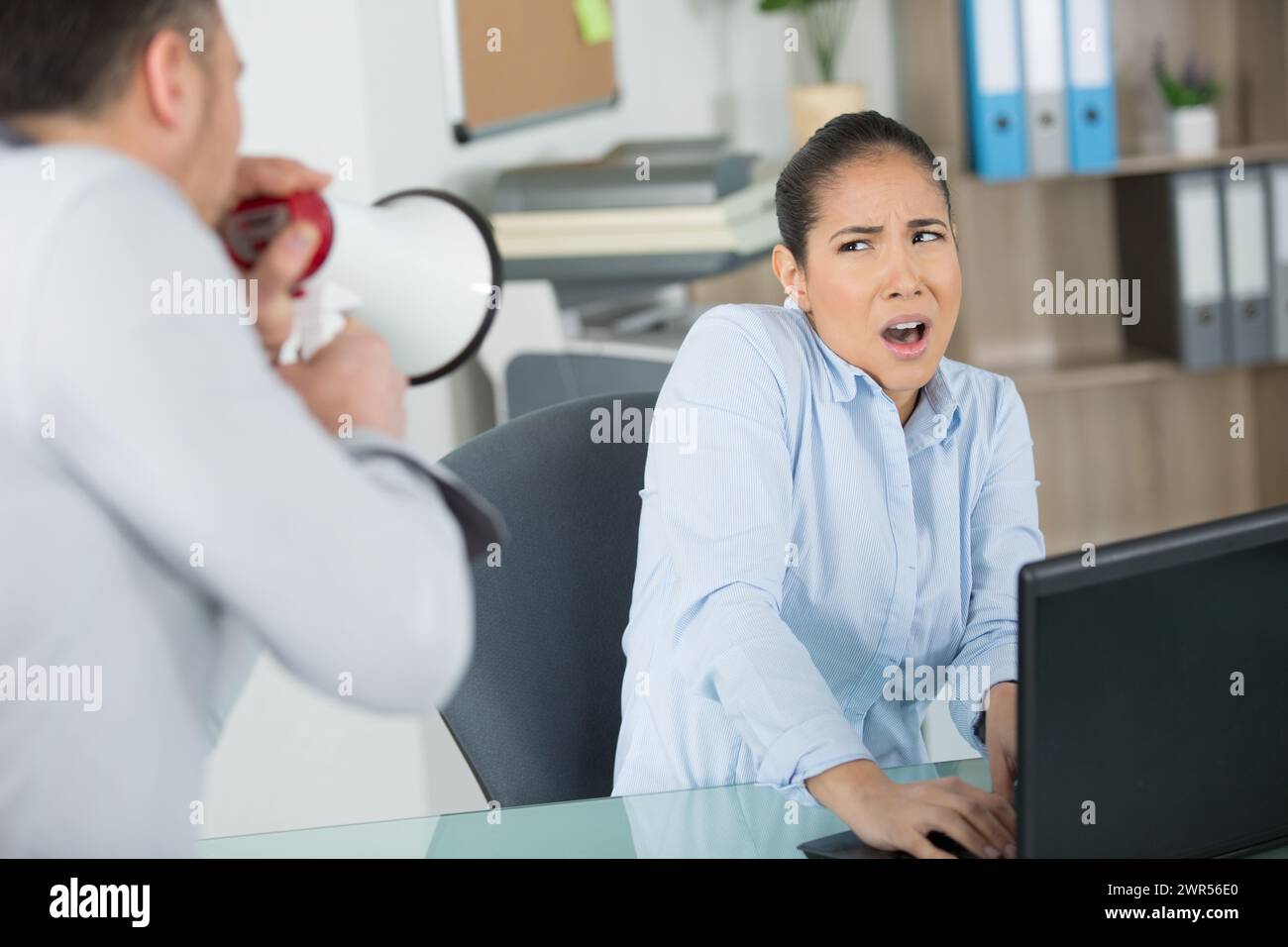 boss shouting at office worker through a megaphone Stock Photo - Alamy