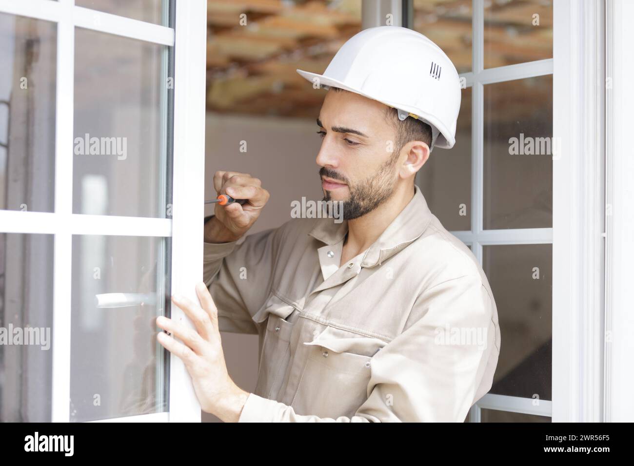 window builder working on mount of new installation Stock Photo - Alamy