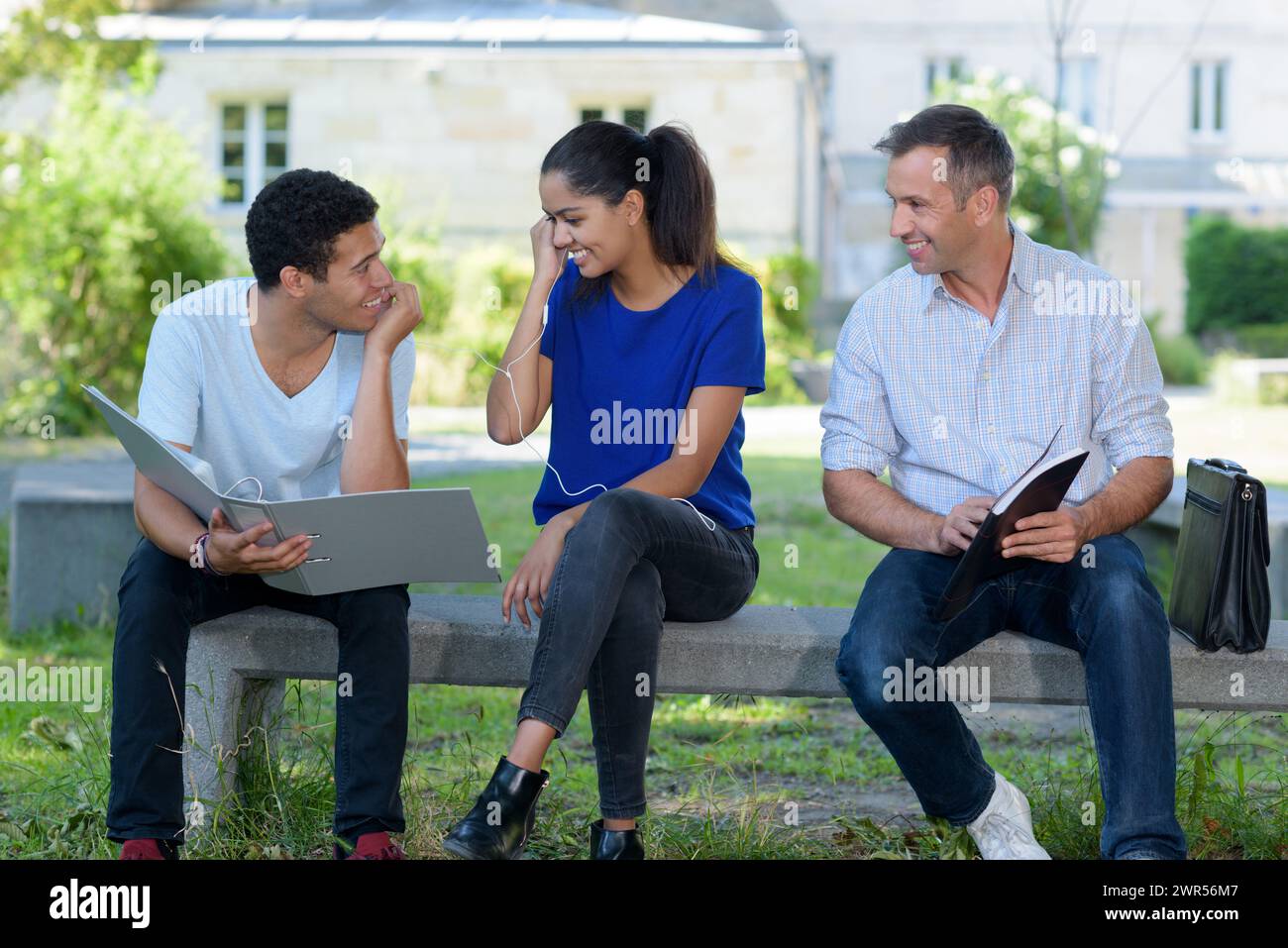 the three students are outdoors Stock Photo - Alamy