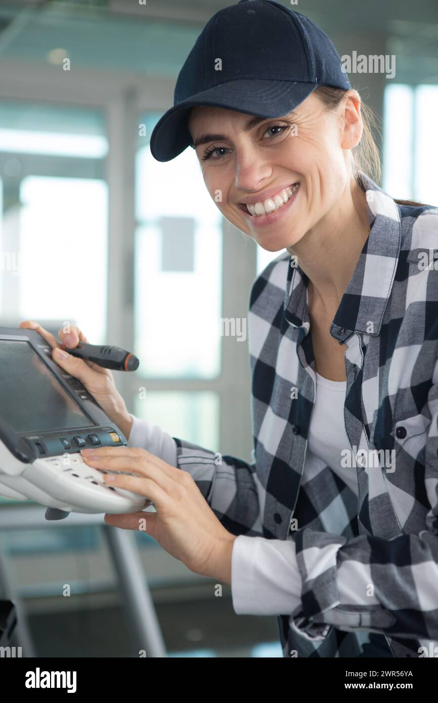 happy woman performing printer maintenance Stock Photo - Alamy