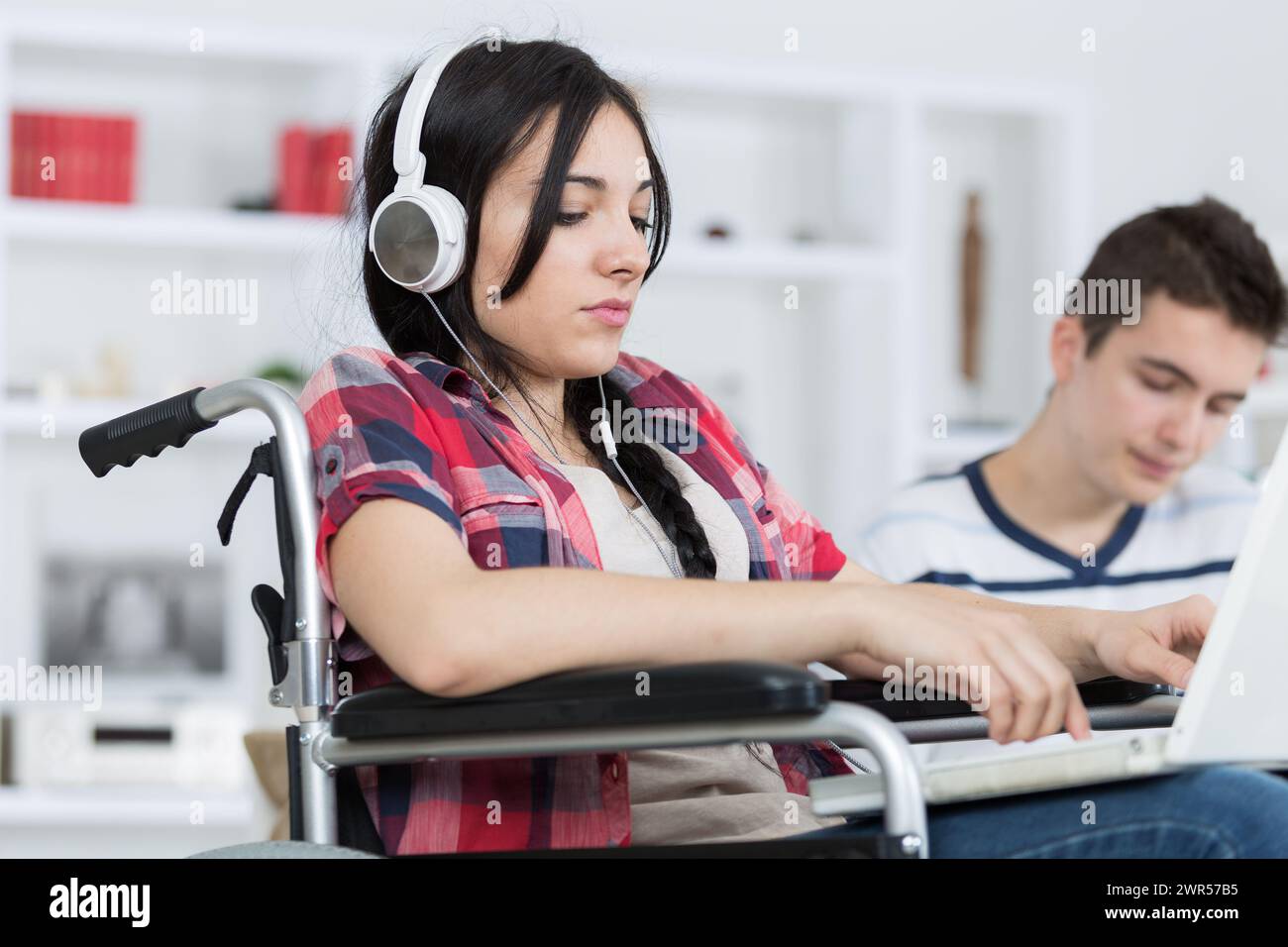 student in wheelchair working with a classmate Stock Photo - Alamy