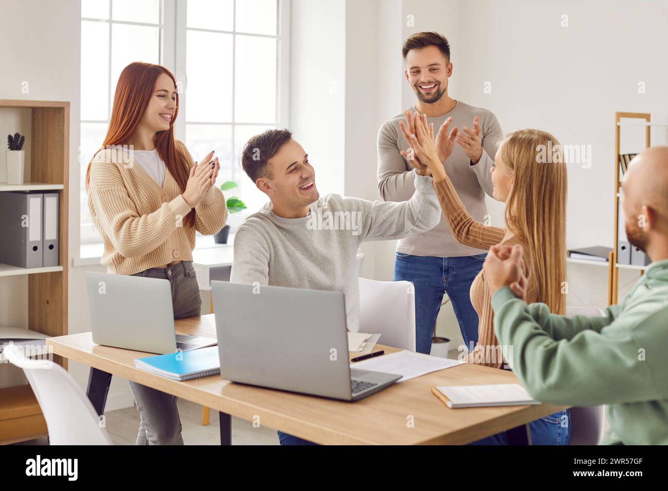 Team of happy, joyful people having fun and celebrating making ...