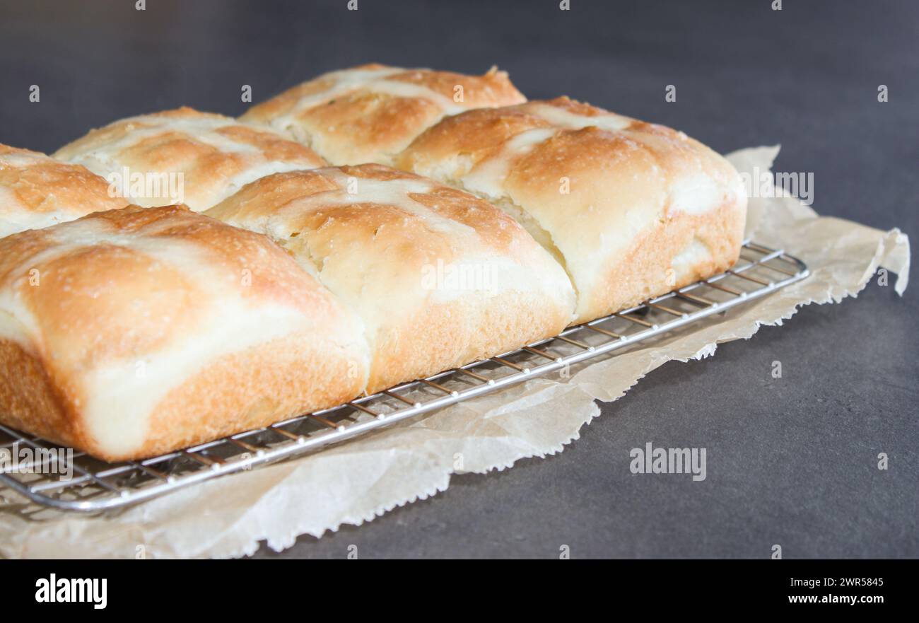 Fresh baked hot cross buns in a baking rack Stock Photo - Alamy