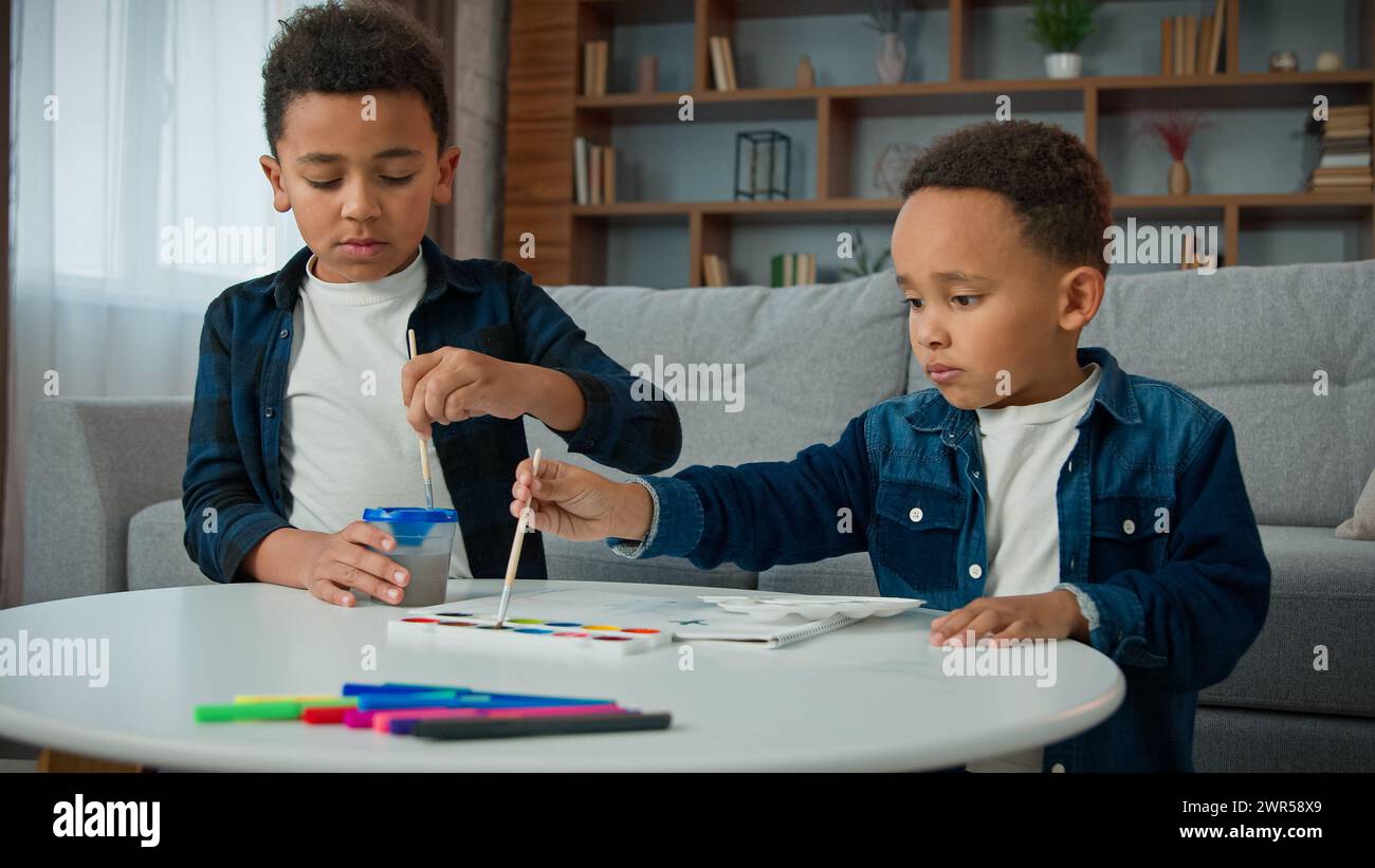 Children concentrate while painting hi-res stock photography and images ...