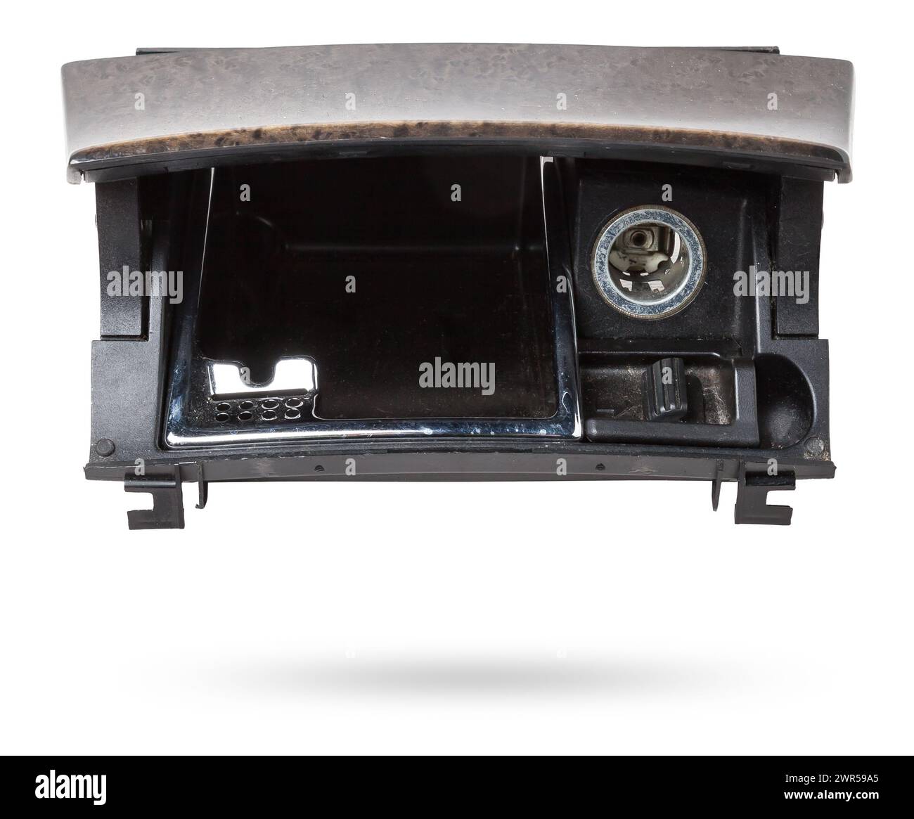 An opened ashtray from panel of car interior separately on a white ...