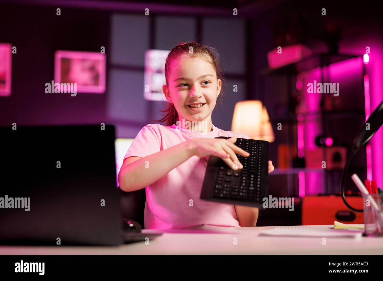 Child influencer filming wireless mechanical keyboard review in studio ...