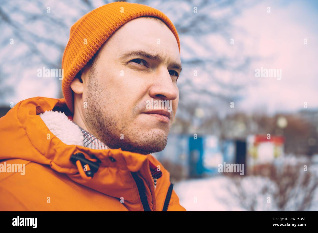 Man Wearing Orange Jacket and Beanie Stock Photo - Alamy