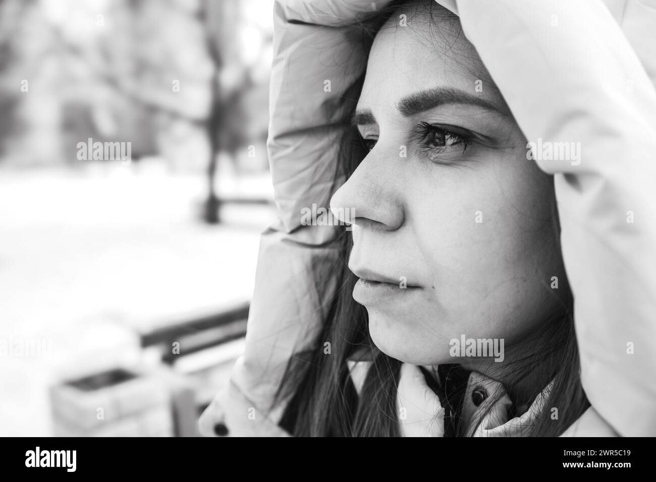 A close-up black and white portrait of a womans face, showcasing her ...