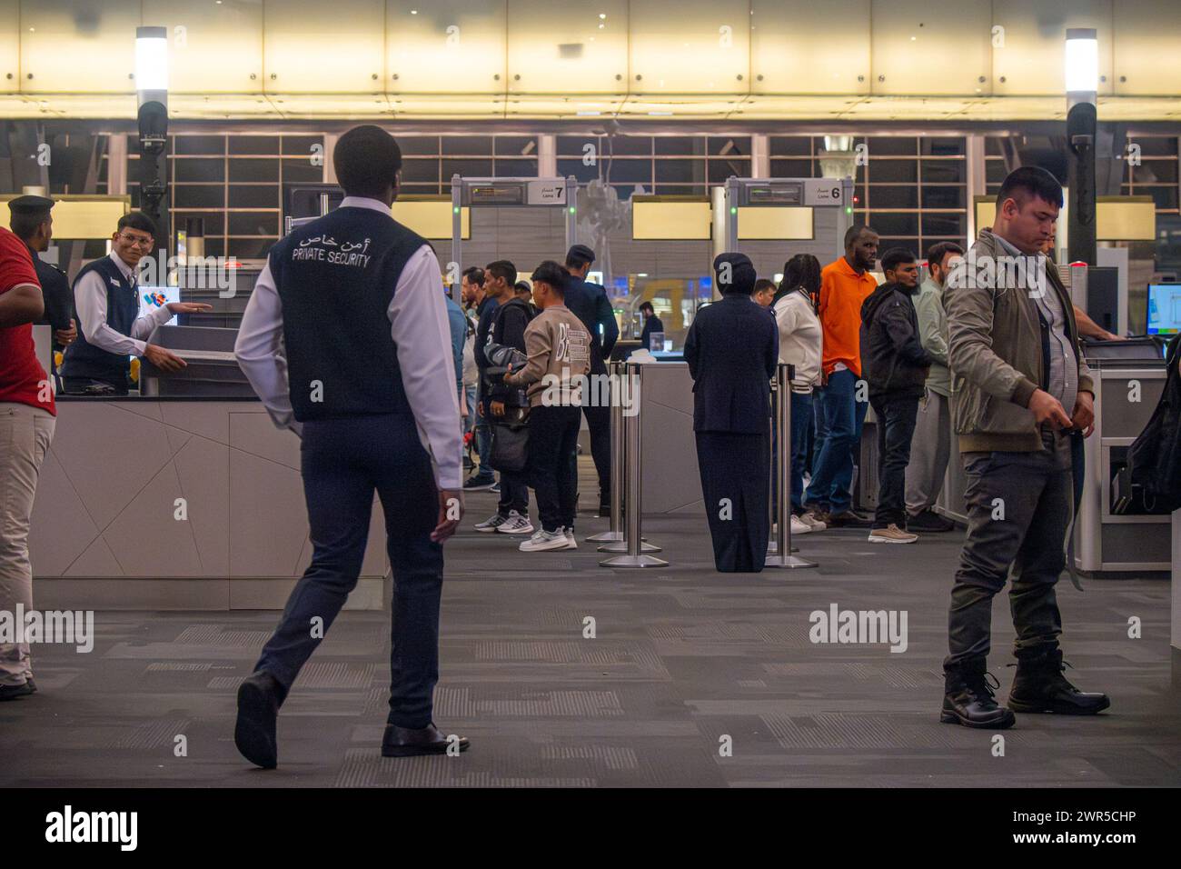 Doha, Qatar. 10th Mar, 2024. Passengers are seen at security check in ...