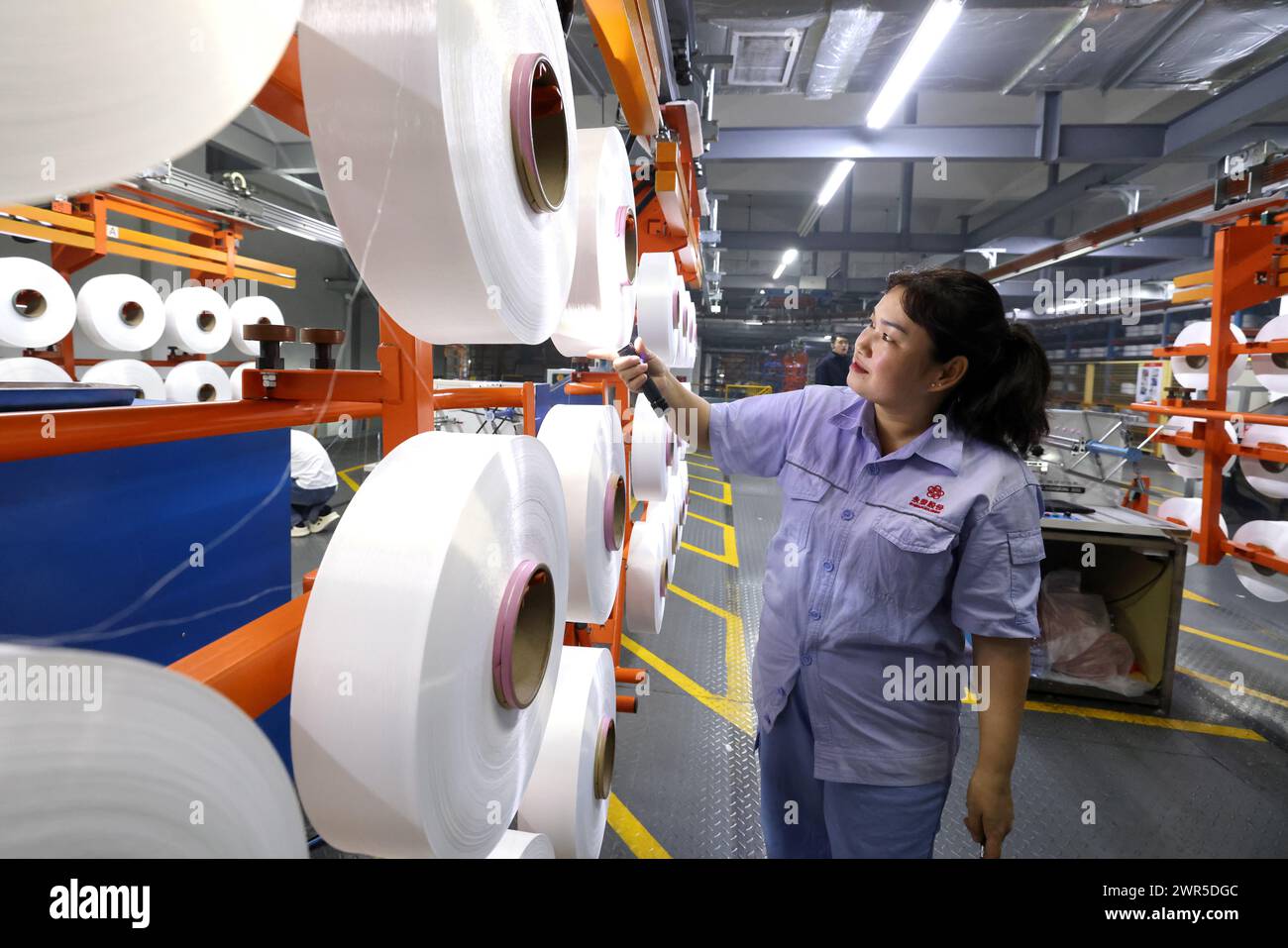 FUZHOU, CHINA - MARCH 11, 2024 - A worker is rushing to make an order ...