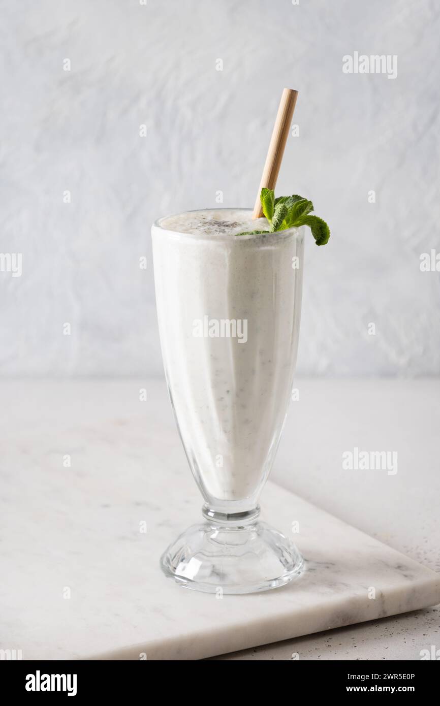 Indian Salty lassi with mint leaves and kala namak on white background ...