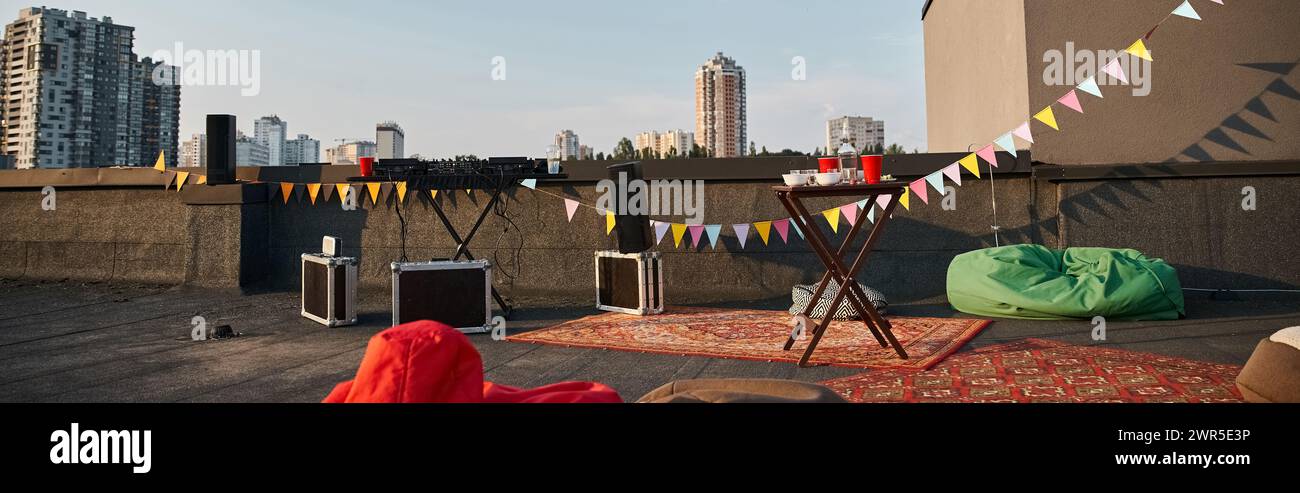 object photo of outdoor rooftop with vivid carpets and DJ equipment ...