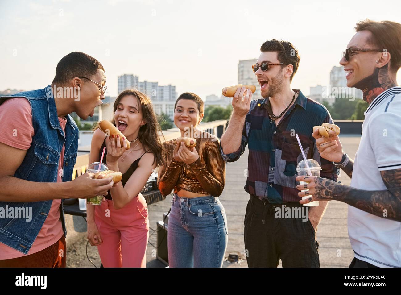 good looking jolly diverse friends in casual outfits eating tasty hot ...