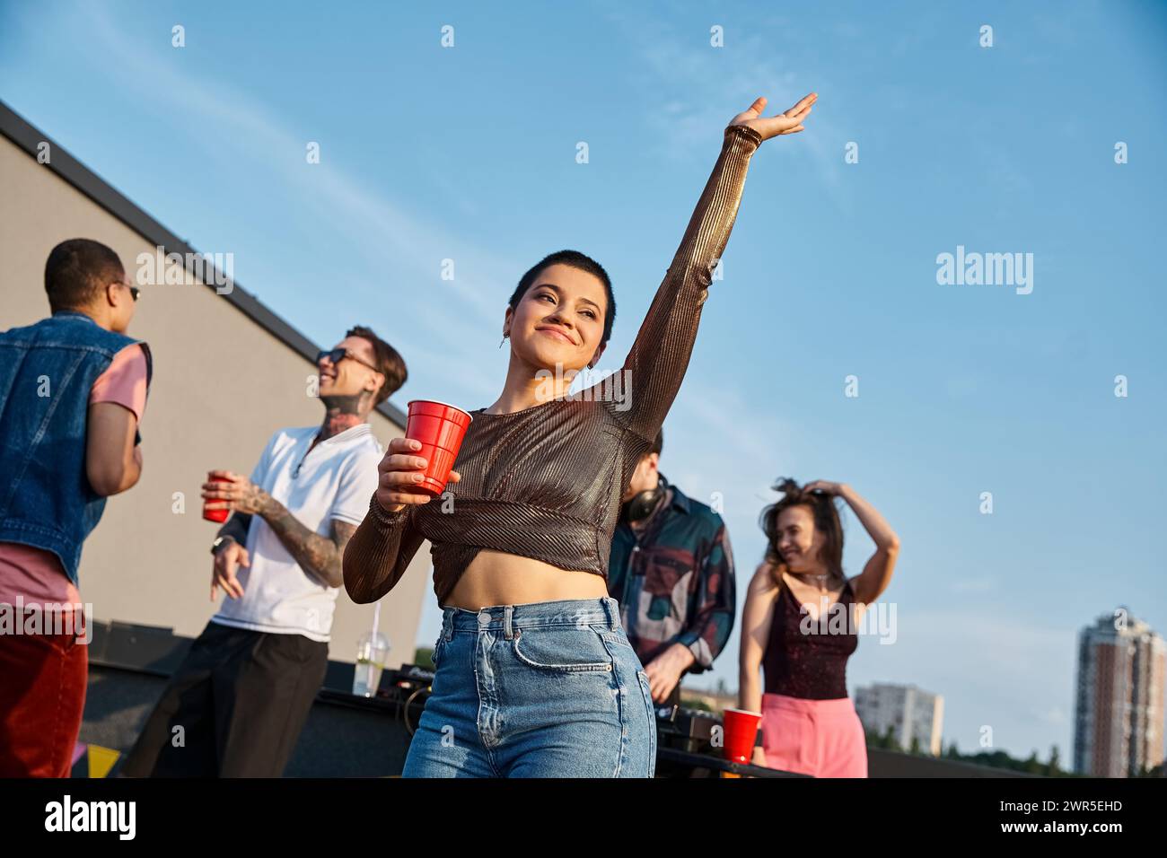 jolly attractive woman in vivid outfit holding cocktail and having fun ...
