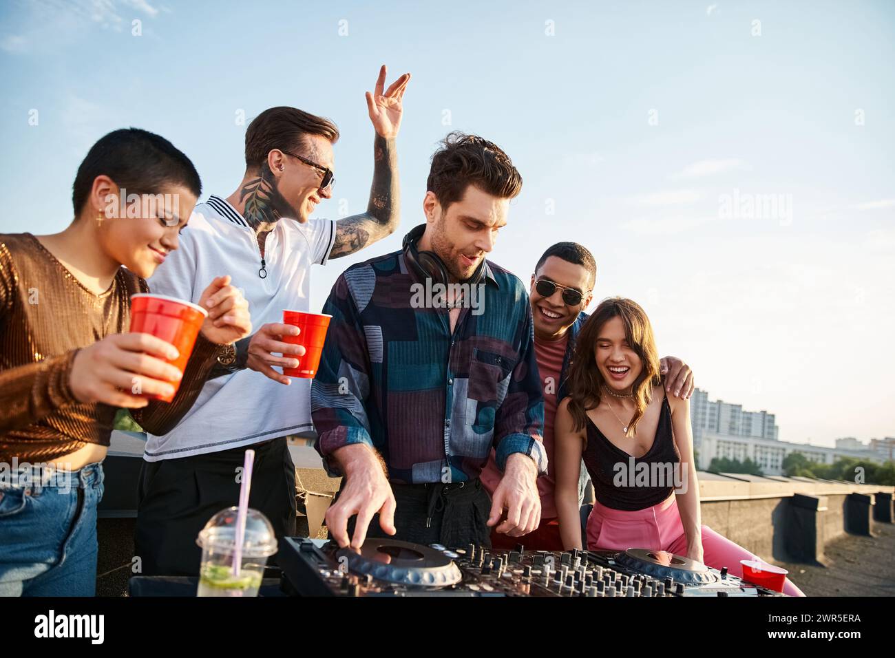 diverse joyful people in vibrant outfits partying together next to ...