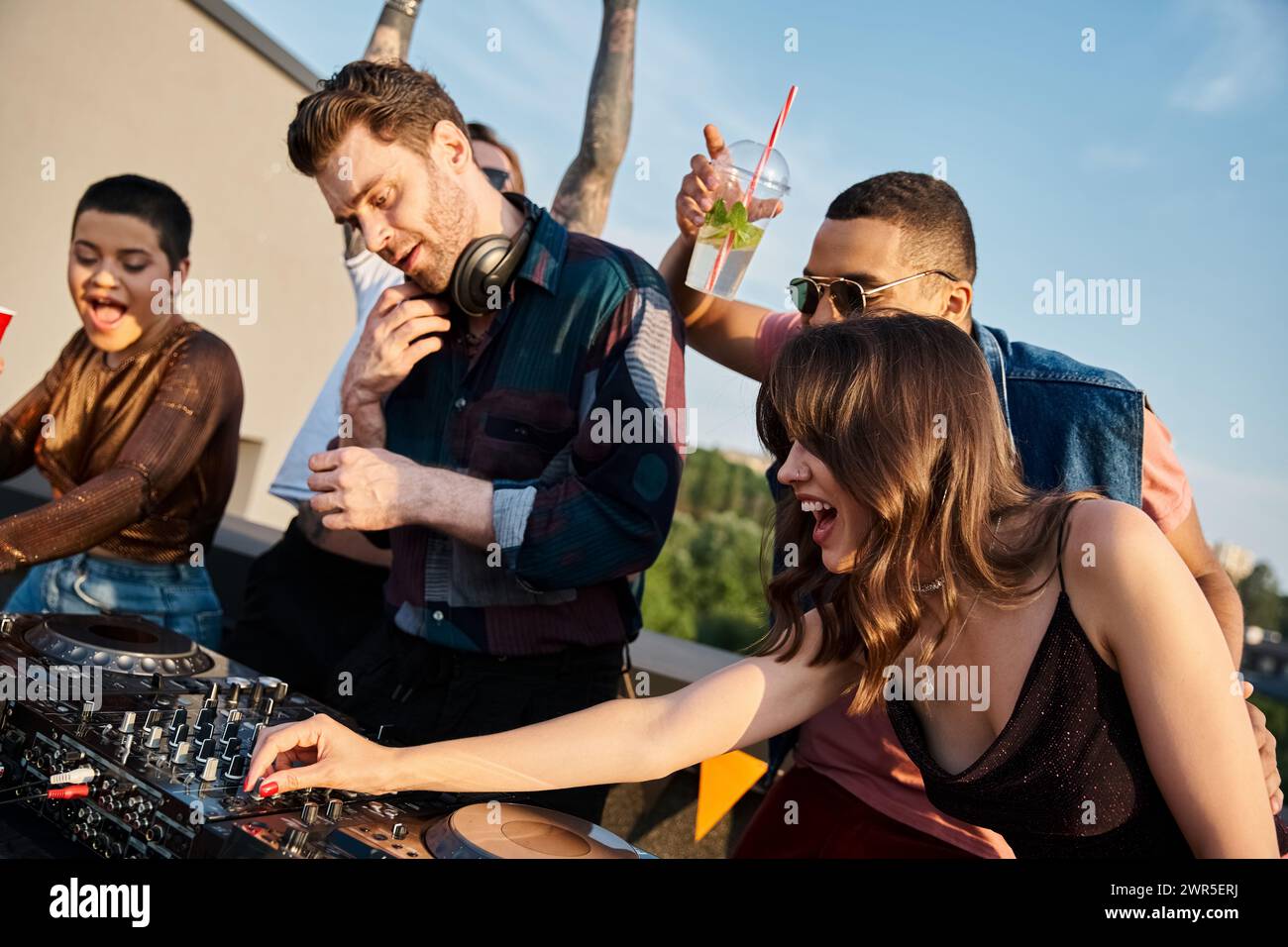 multiracial cheerful people in vibrant outfits partying together next ...