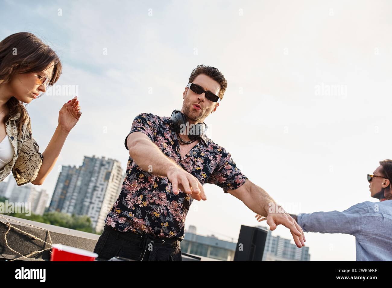 young attractive joyous people in stylish attires with cocktails ...